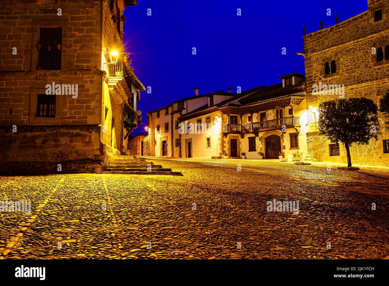 Old town street with cobblestone ground at dusk. Santillana del Mar ...