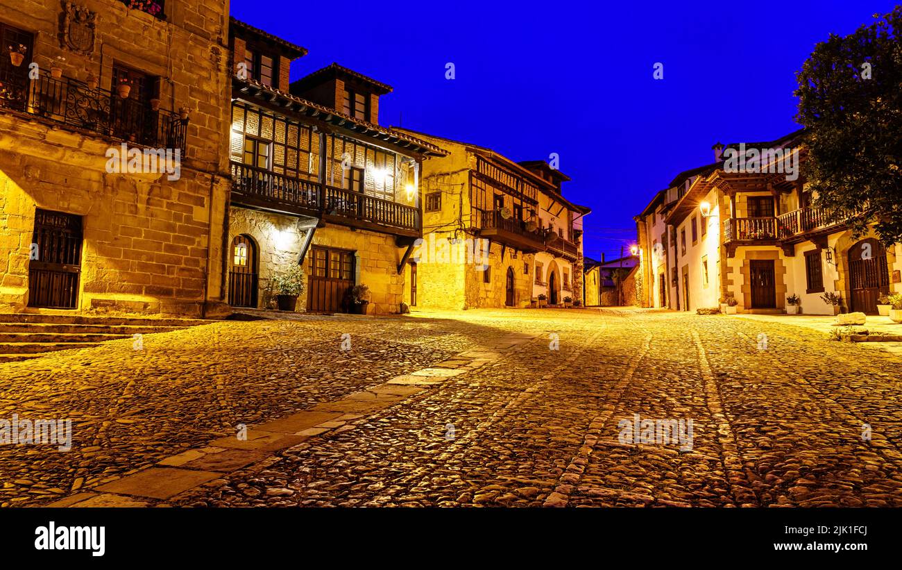 Old town street with cobblestone ground at dusk. Santillana del Mar ...