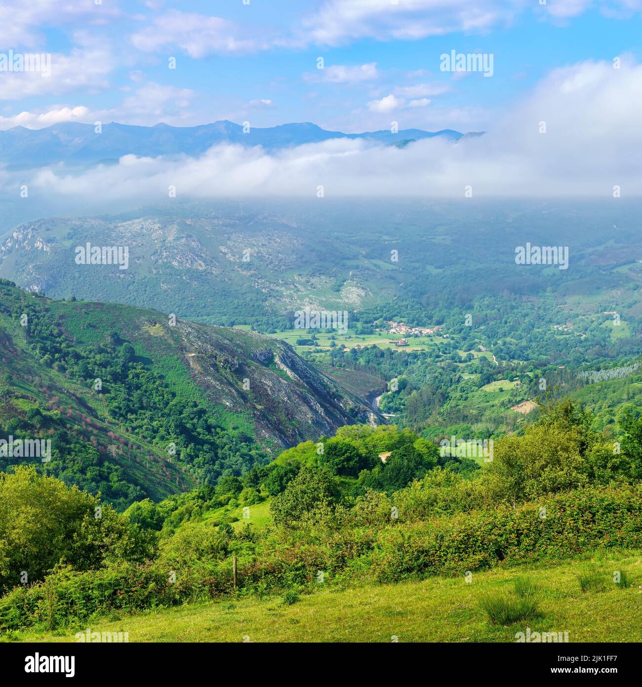 Aerial view of a green mountain landscape with houses in the valley ...