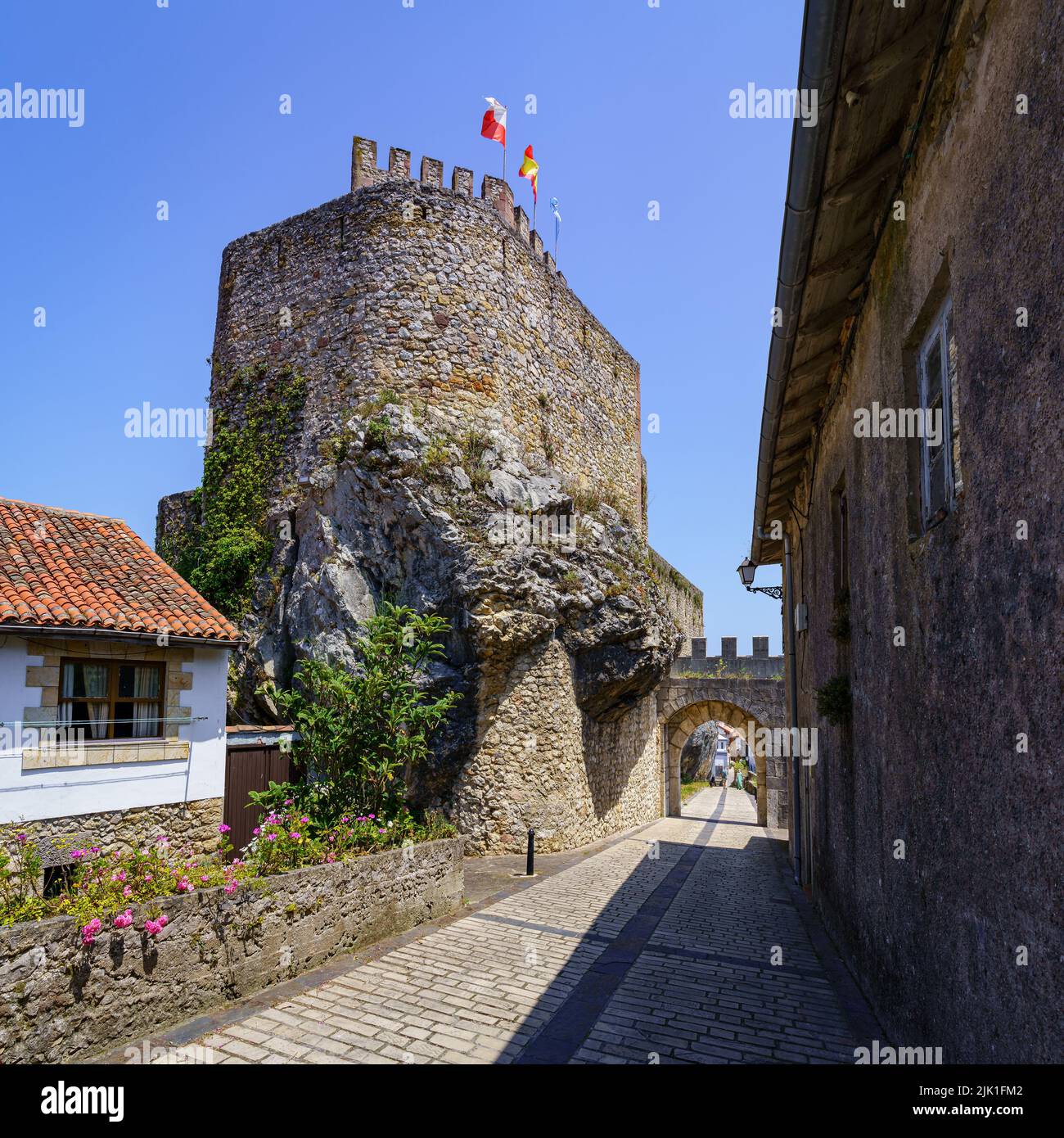 Medieval castle with narrow lane and entrance arch under the wall. San ...