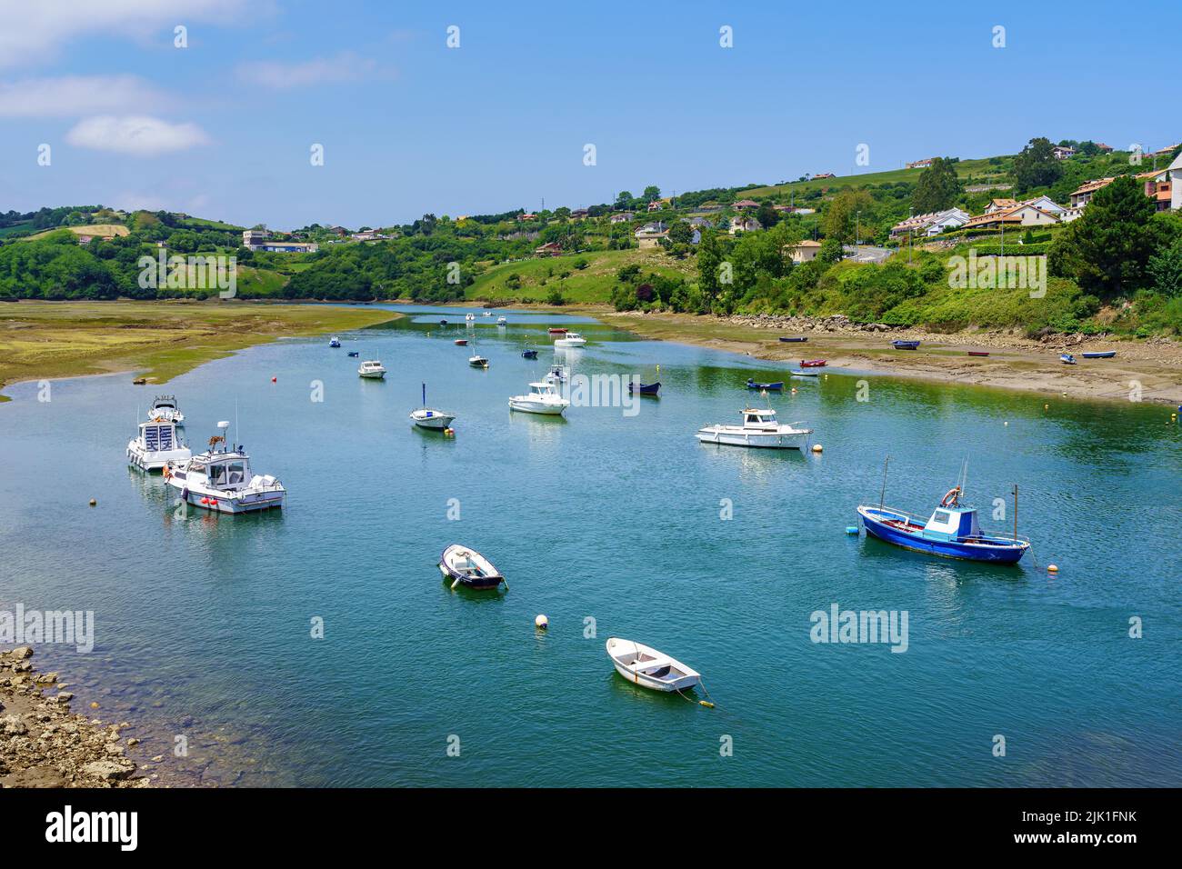 Estuary of the sea with small boats anchored and blue sky in summer ...