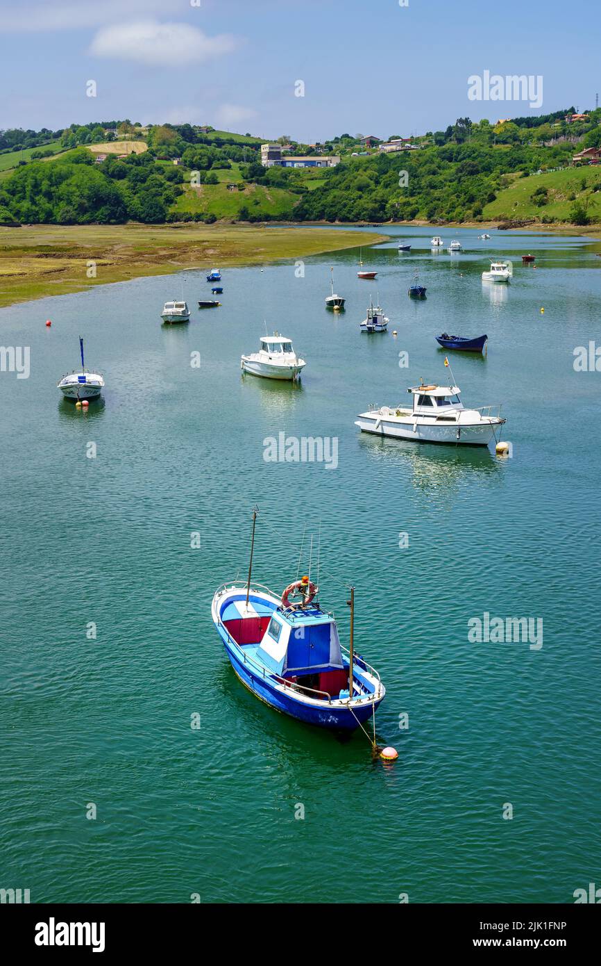Estuary of the sea with small boats anchored and blue sky in summer ...