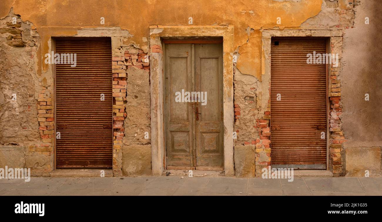 Three old doors in a derelict building in the medieval centre of Izola ...
