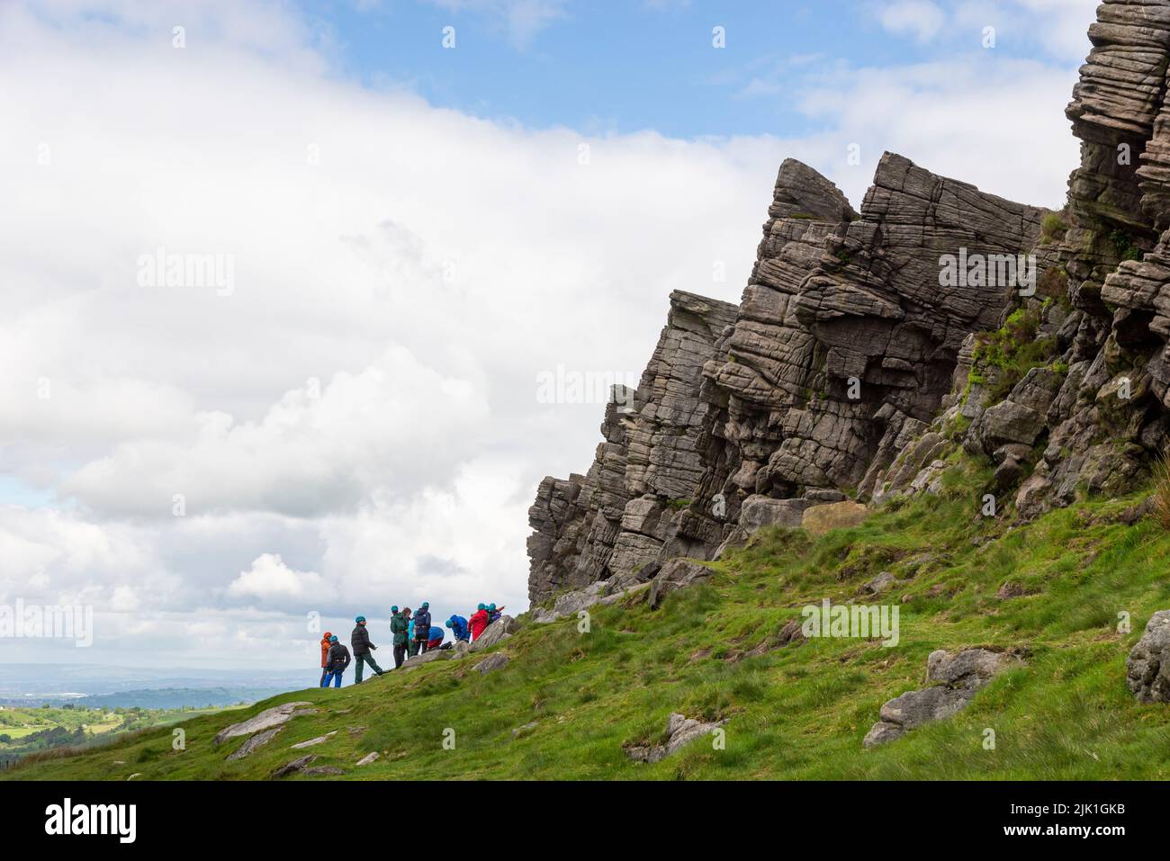 Group of novice rock climbers at Windgather rocks on the Cheshire ...
