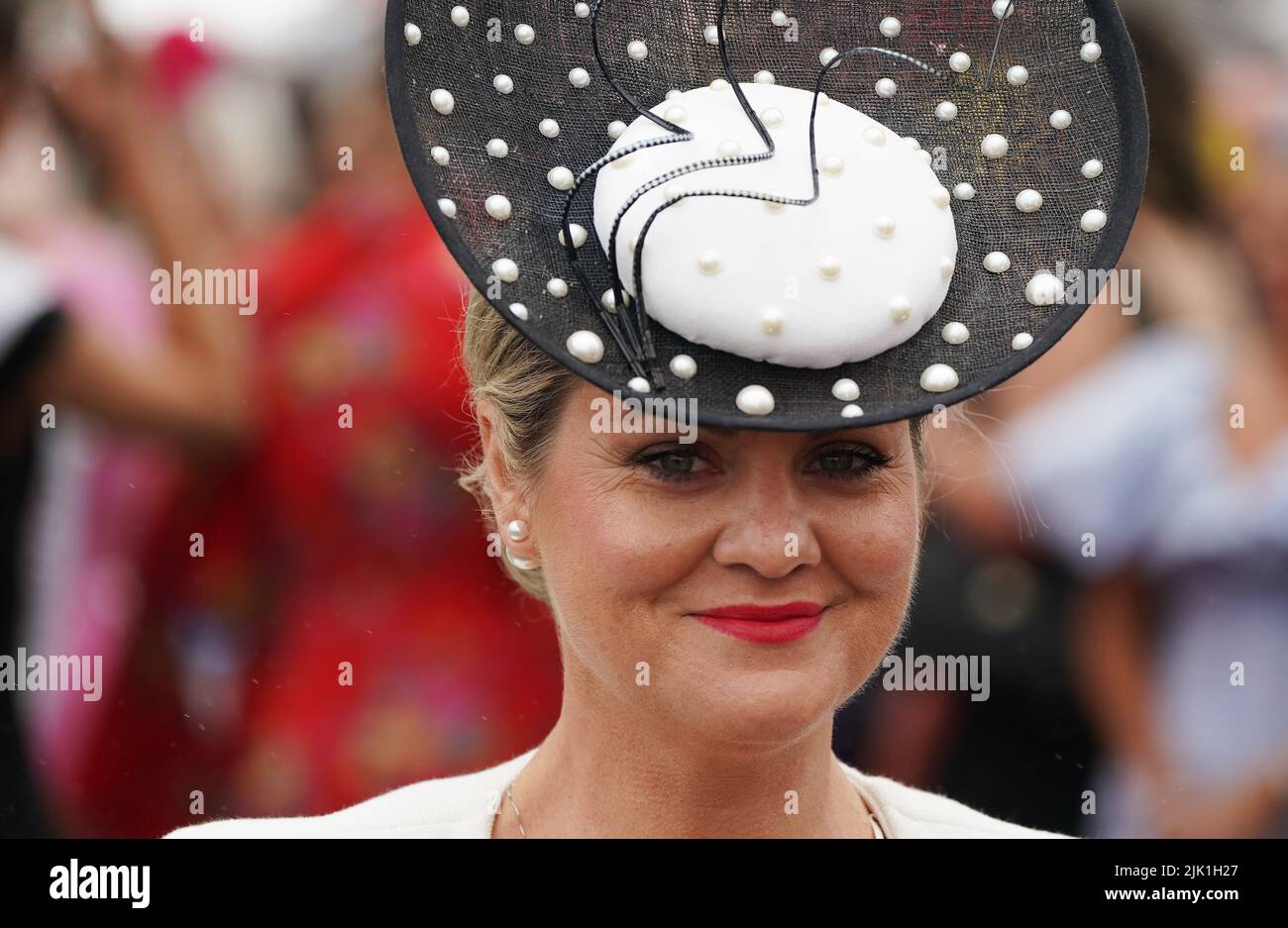 A Racegoers arrive as the rain begins to fall during day five of the ...