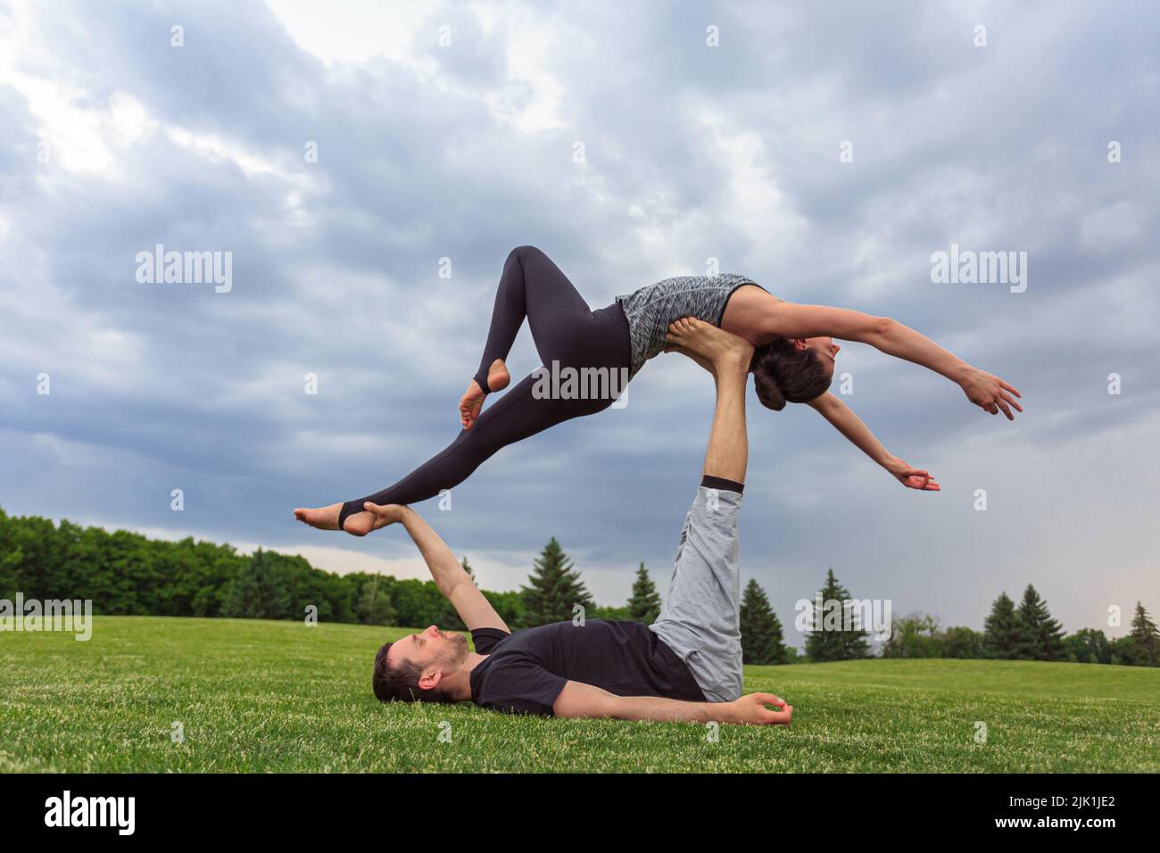 Strong acrobatic woman lifting man hi-res stock photography and images ...