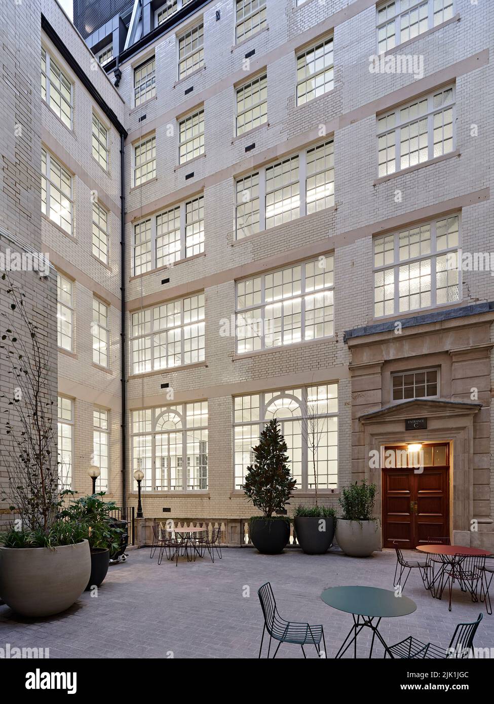 Internal open air courtyard with original facade at dusk. The Gilbert ...