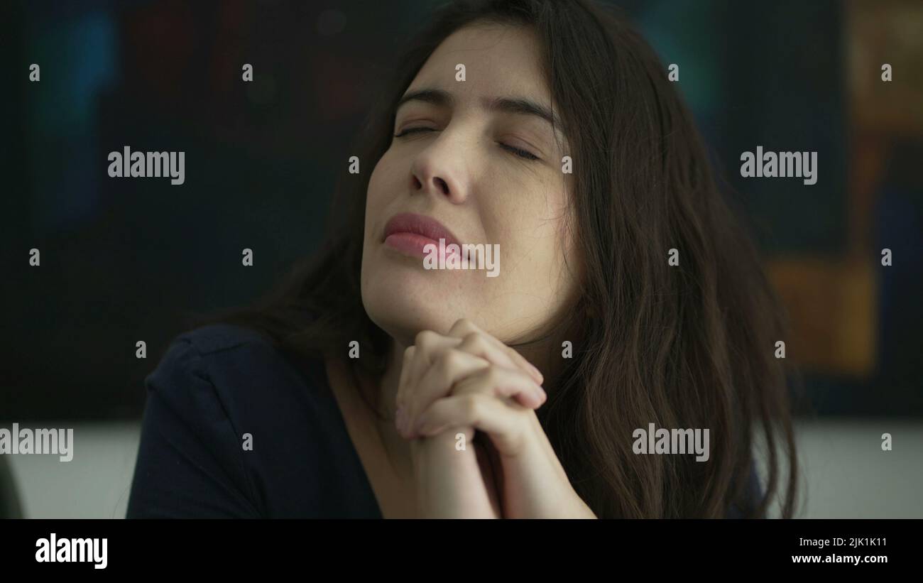 Woman with preoccupied expression closing eyes with regret. Person ...