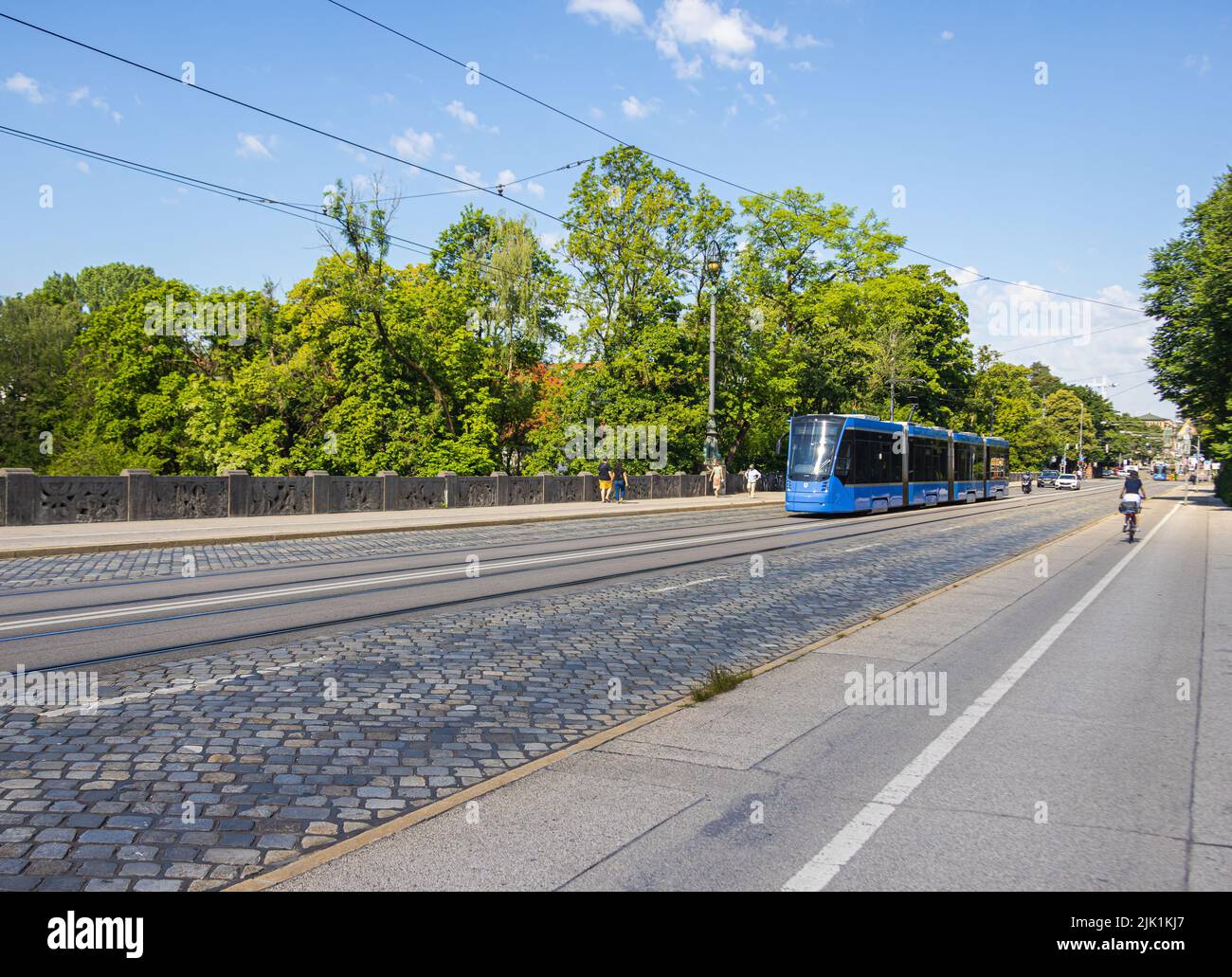 Munich, Germany - July 6, 2022: A tram passing the Maximiliansbrücke ...