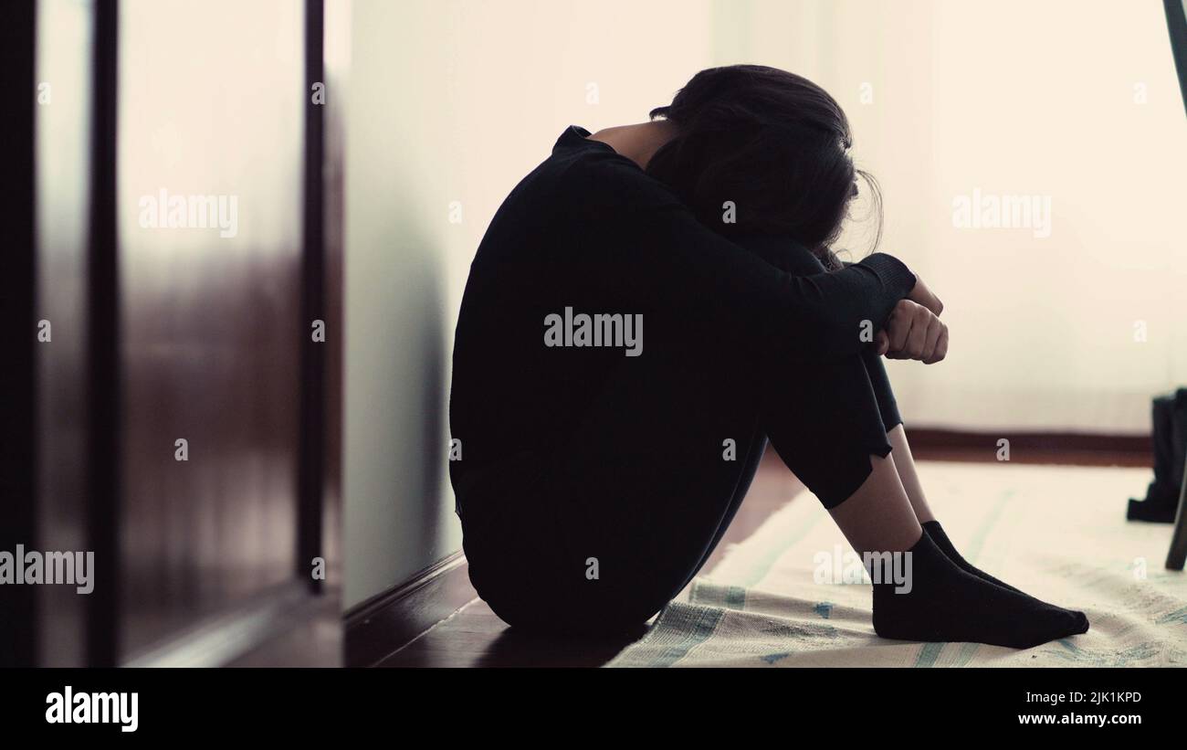 Fearful Depressed Person Sitting On Floor Covering Face In Fetal Position Desperate Woman