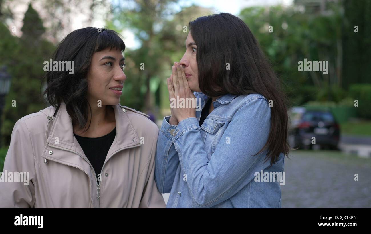 Female friend reacting with shock and surprise to news while walking ...