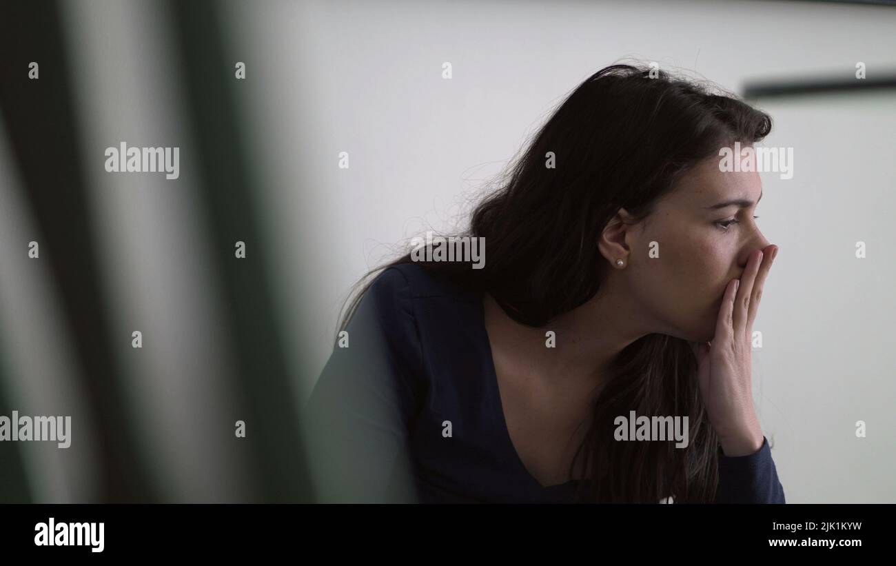 Hopeless woman covering face in shame and regret feeling emotional anguish sitting on floor at ...