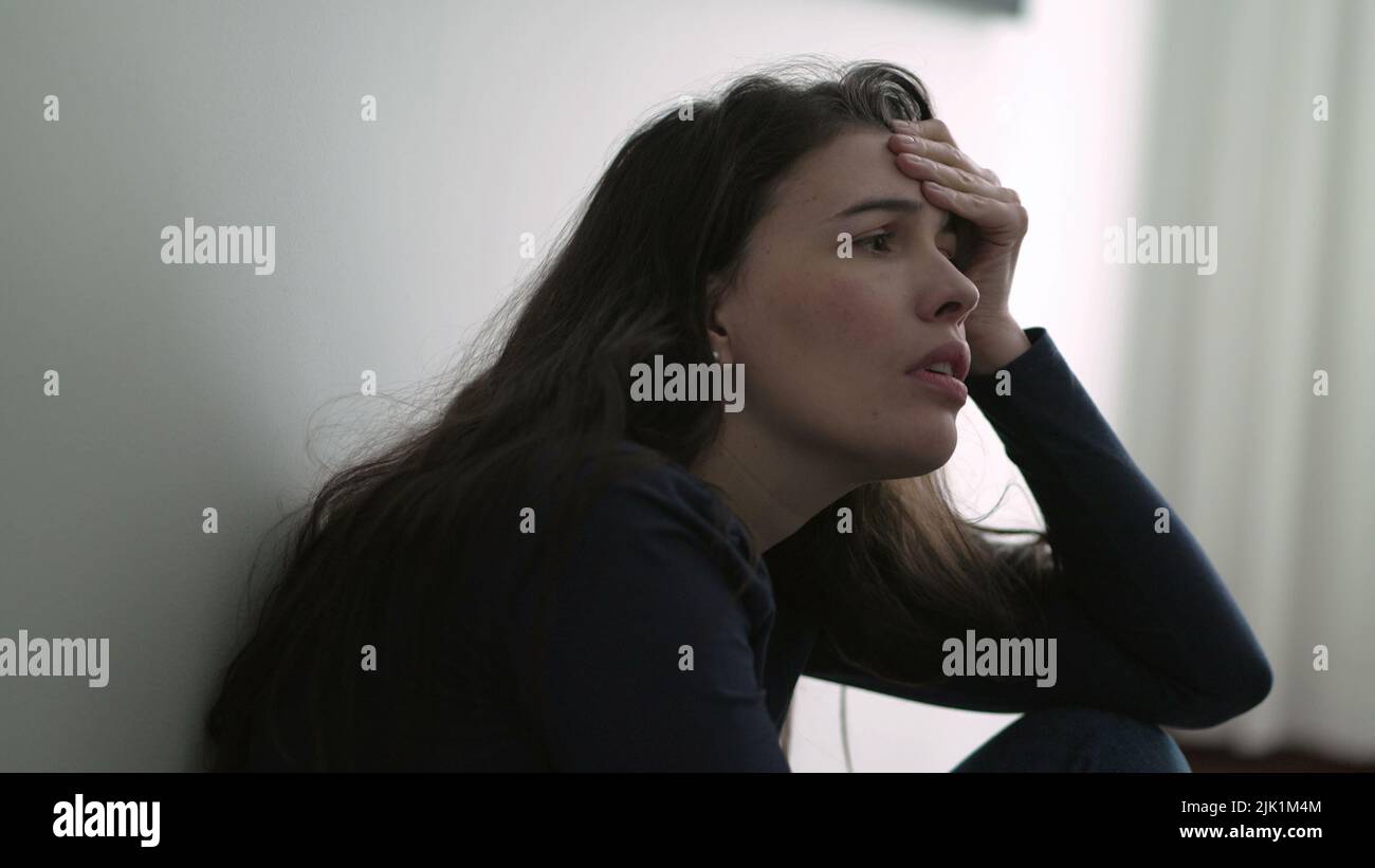 Nervous woman suffering from depression sitting on floor. Frustrated ...