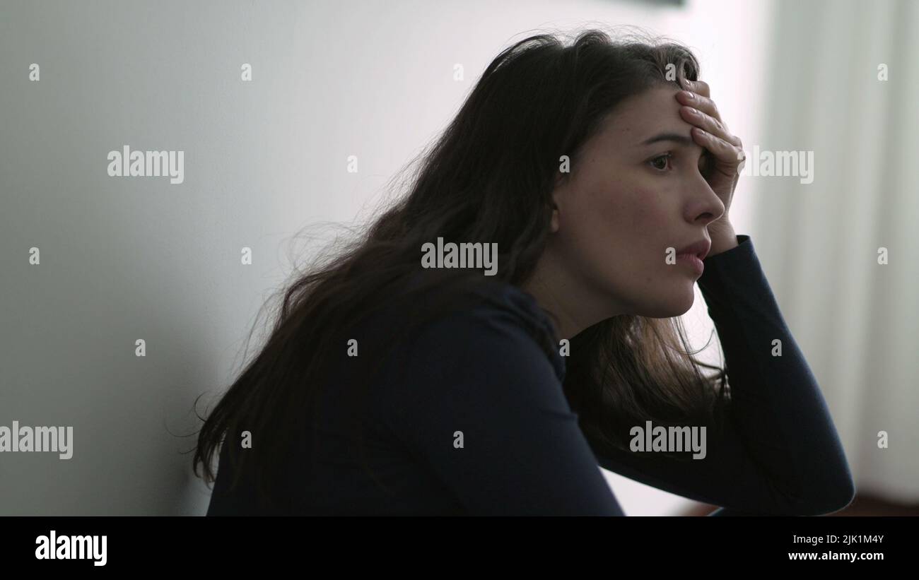 Nervous woman suffering from depression sitting on floor. Frustrated ...