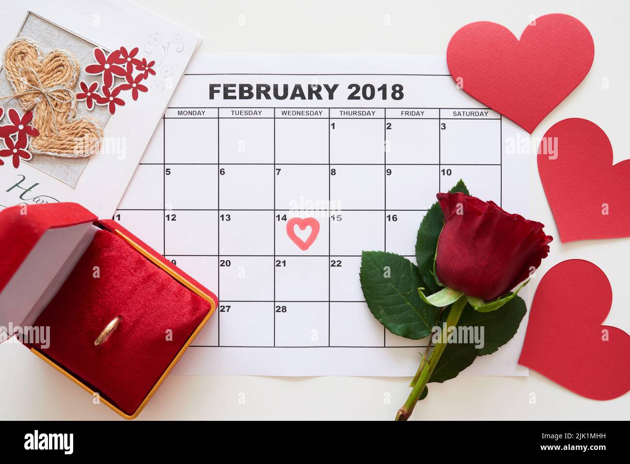 Engagement ring and a rose ready for Valentines day Stock Photo - Alamy