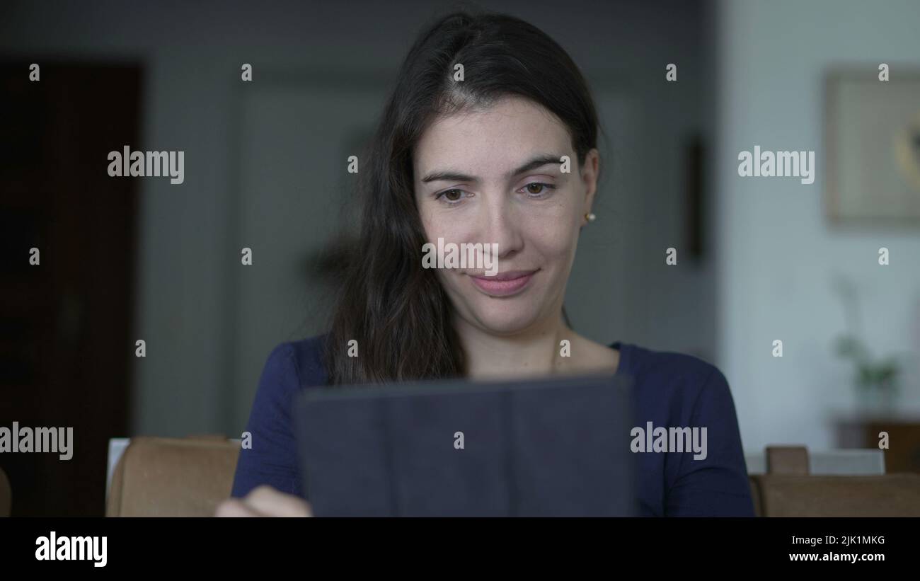 Close up woman face looking at tablet screen smiling. Portrait person ...
