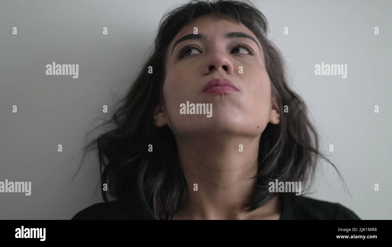 Close up woman face with frustrated emotion pondering solution to ...