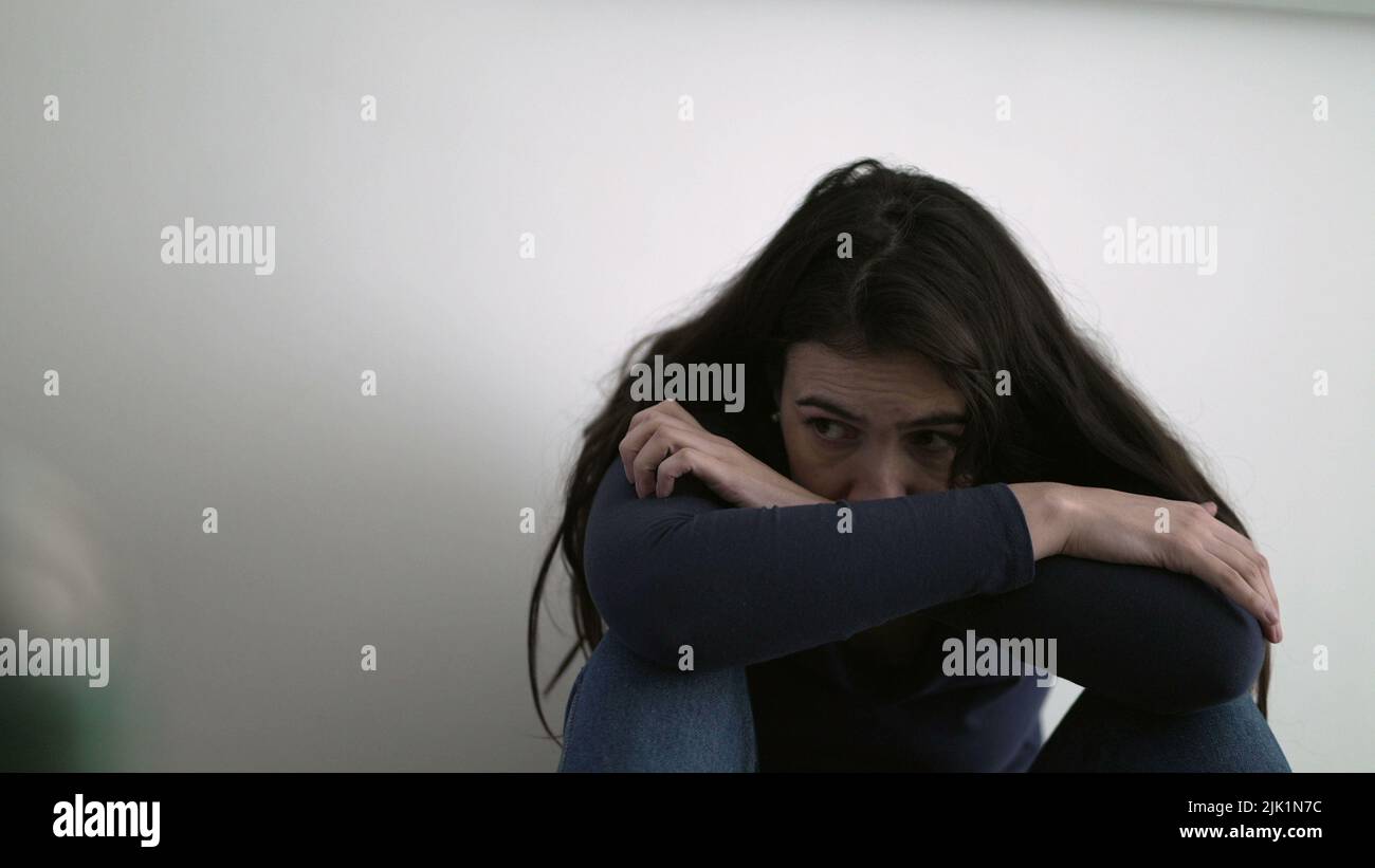 One fearful person overwhelmed with emotional problems. Ashamed woman ...