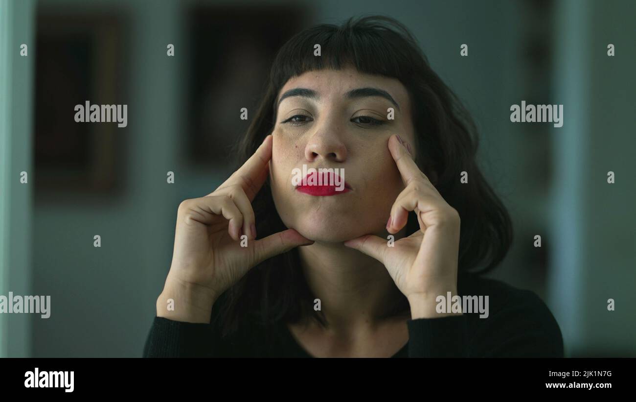 One concentrated hispanic latin girl closeup face introspective emotion ...