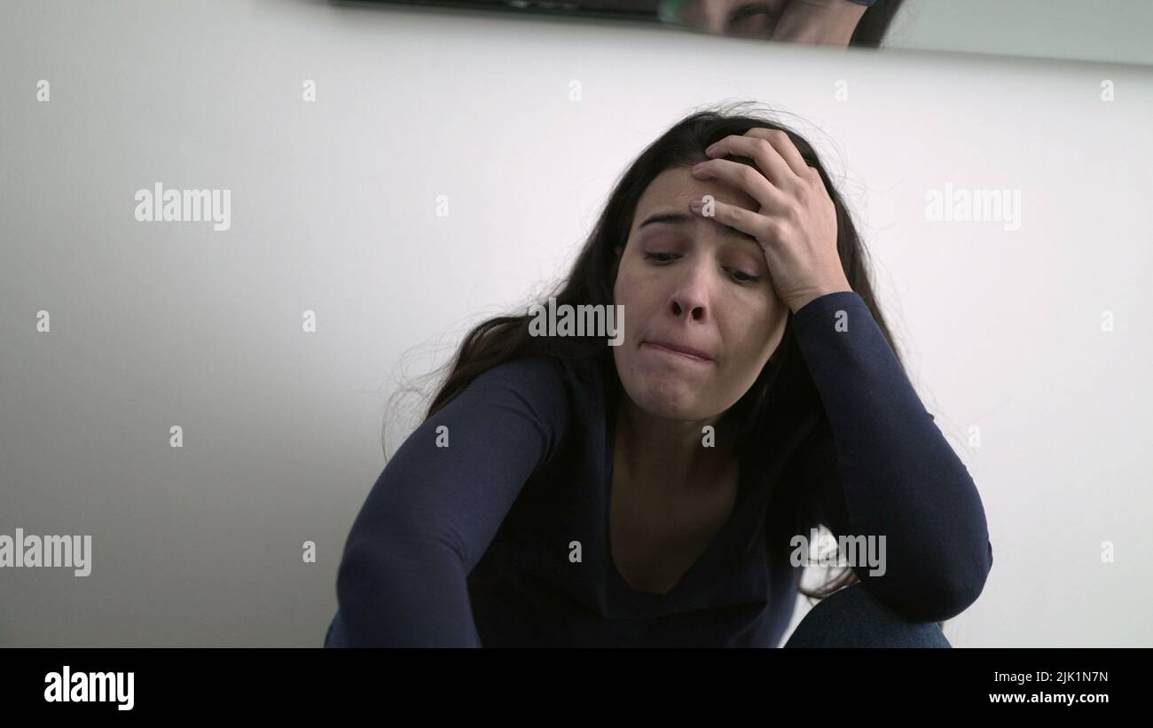 One fearful person overwhelmed with emotional problems. Ashamed woman ...