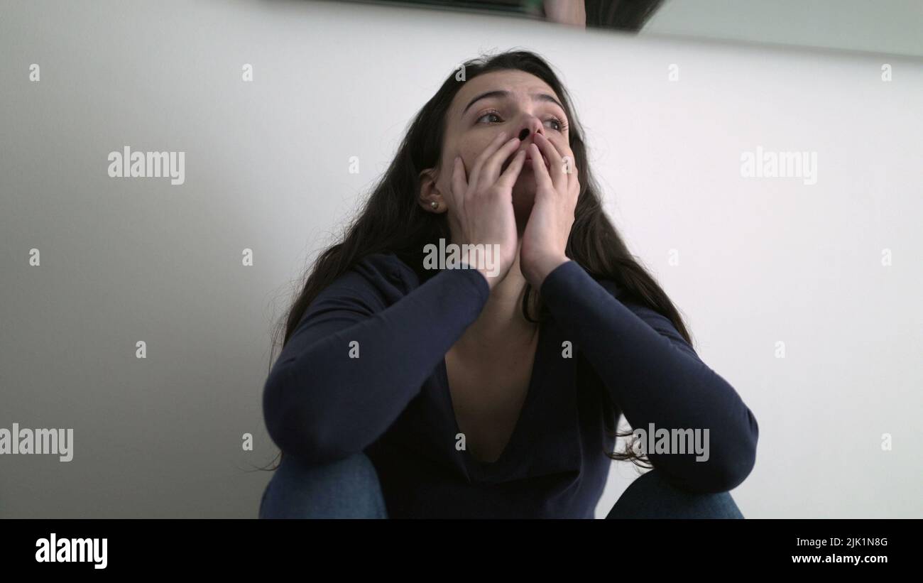 One fearful person overwhelmed with emotional problems. Ashamed woman ...