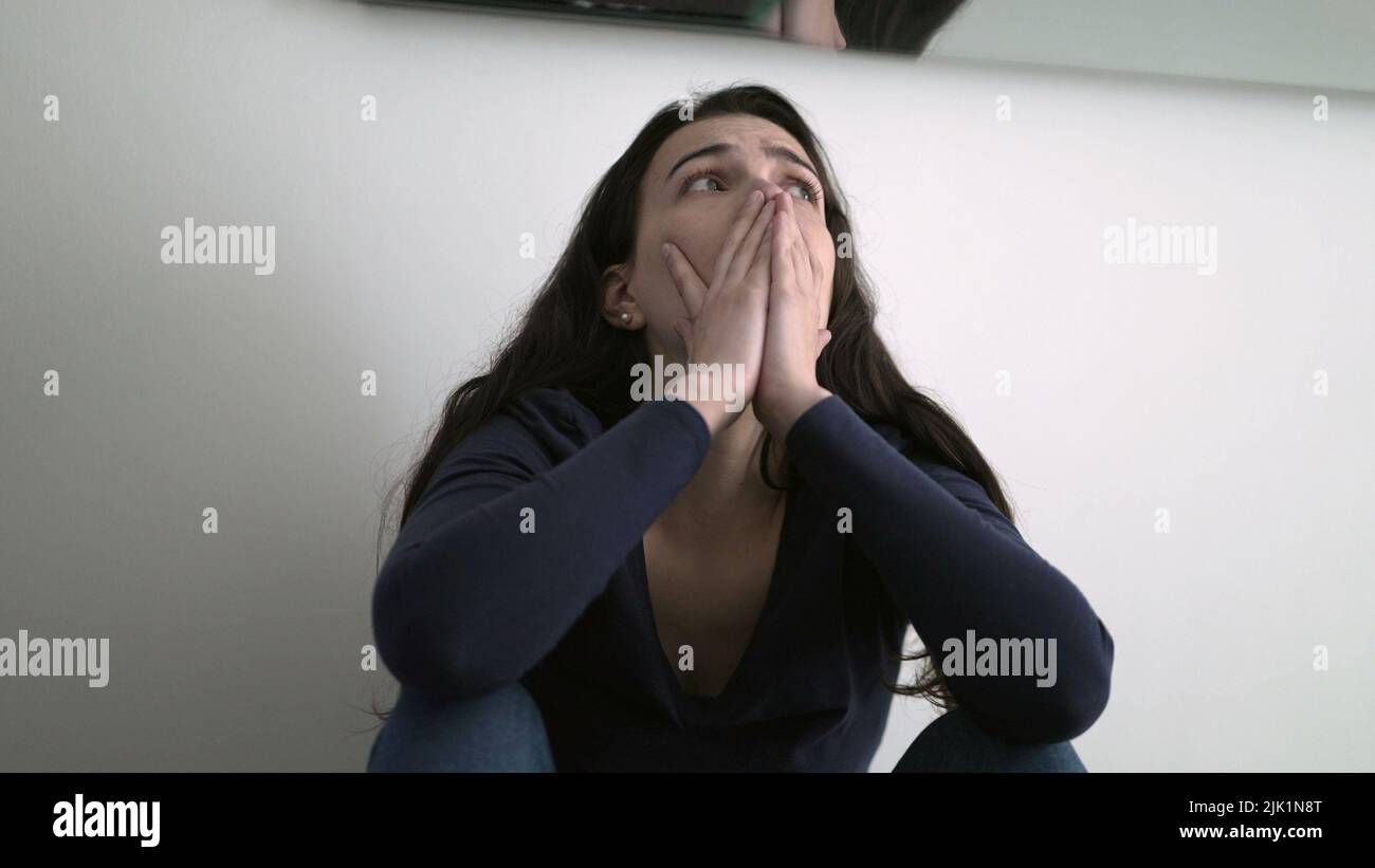 One fearful person overwhelmed with emotional problems. Ashamed woman ...