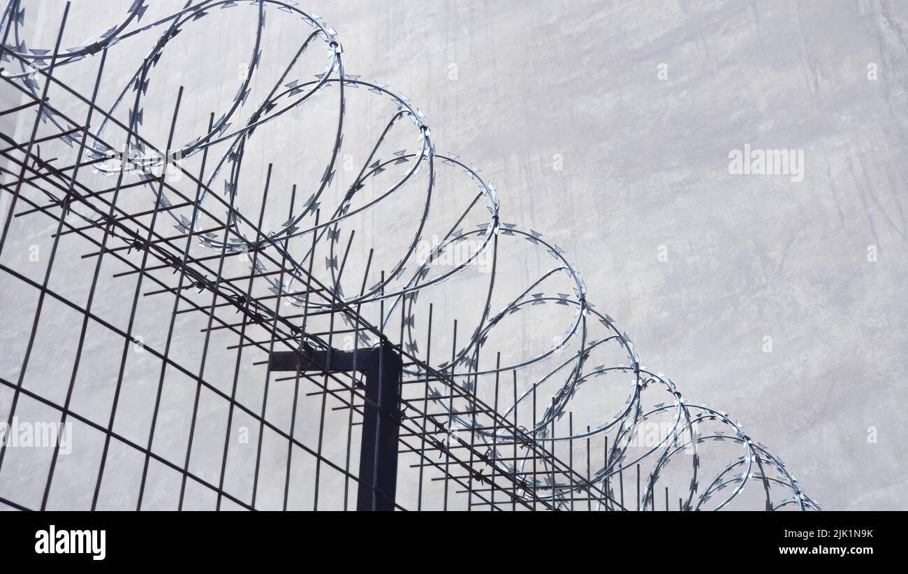 Title Concertina barb wire, heavy duty, metal fence. A prison, crime ...