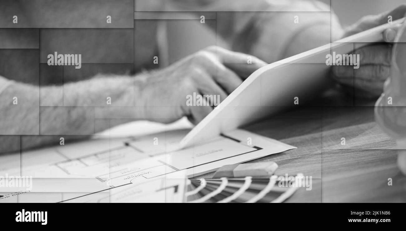 Architect working on a project and using a digital tablet, geometric ...