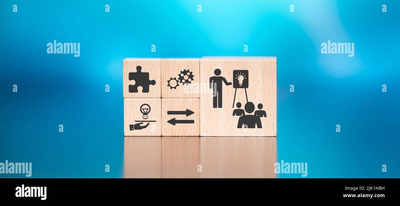 Wooden blocks with symbol of knowledge sharing concept on blue ...
