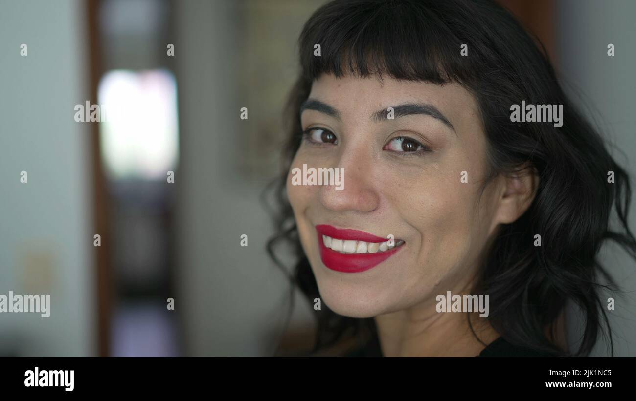 One South American woman with serious expression portrait face wearing ...