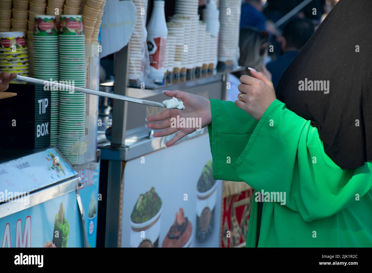 Turkish ice cream vendor jokes and customers having fun. Traditional ...