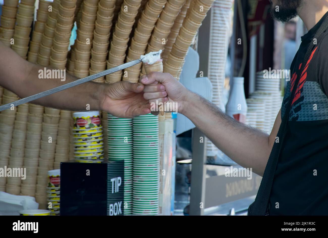 Turkish ice cream vendor jokes and customers having fun. Traditional ...