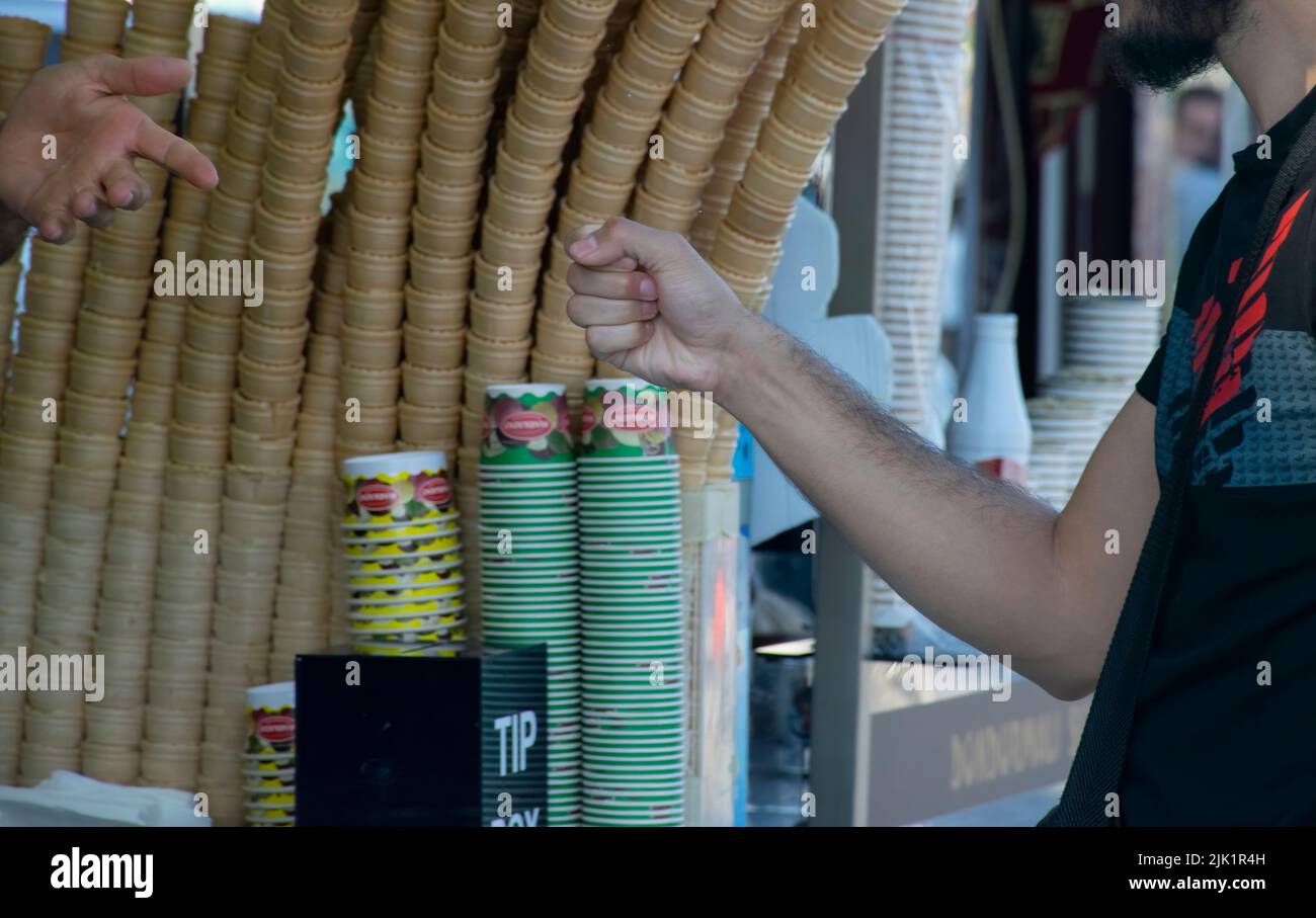 Turkish ice cream vendor jokes and customers having fun. Traditional ...