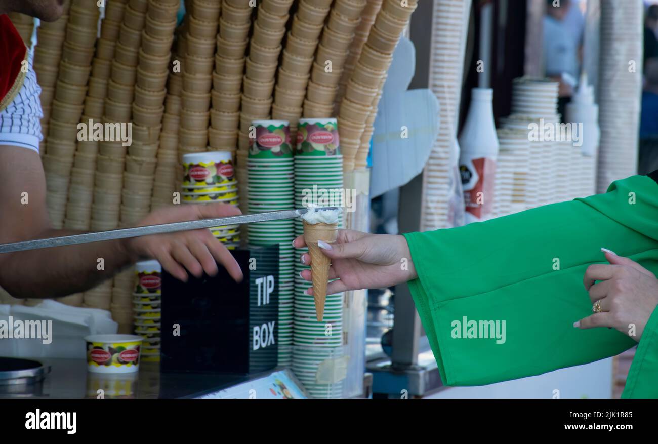 Turkish ice cream vendor jokes and customers having fun. Traditional ...