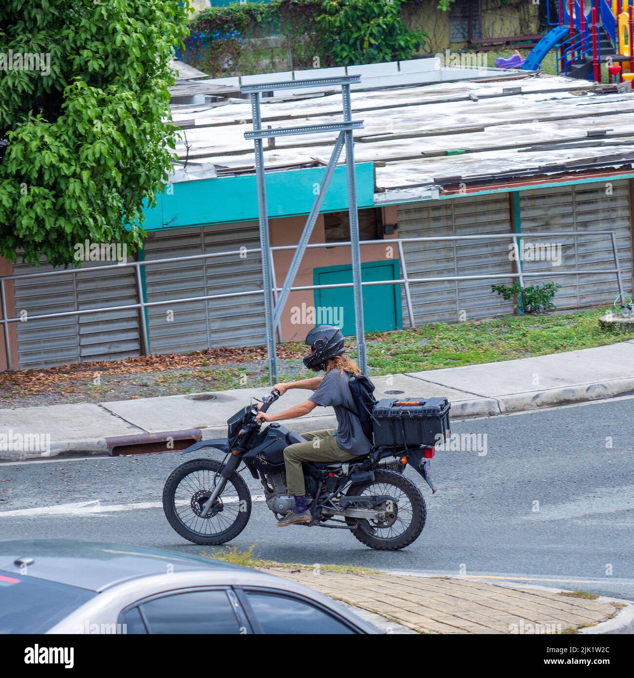 Man on a motorcycle in the U.S. Virgin Islands Stock Photo - Alamy
