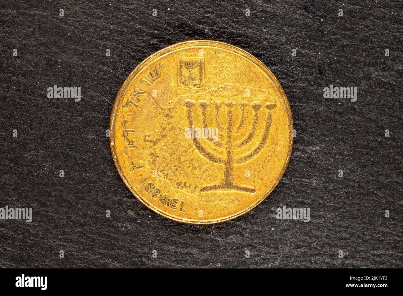 One Israeli metal coin on a slate stone, close-up, top view Stock Photo ...