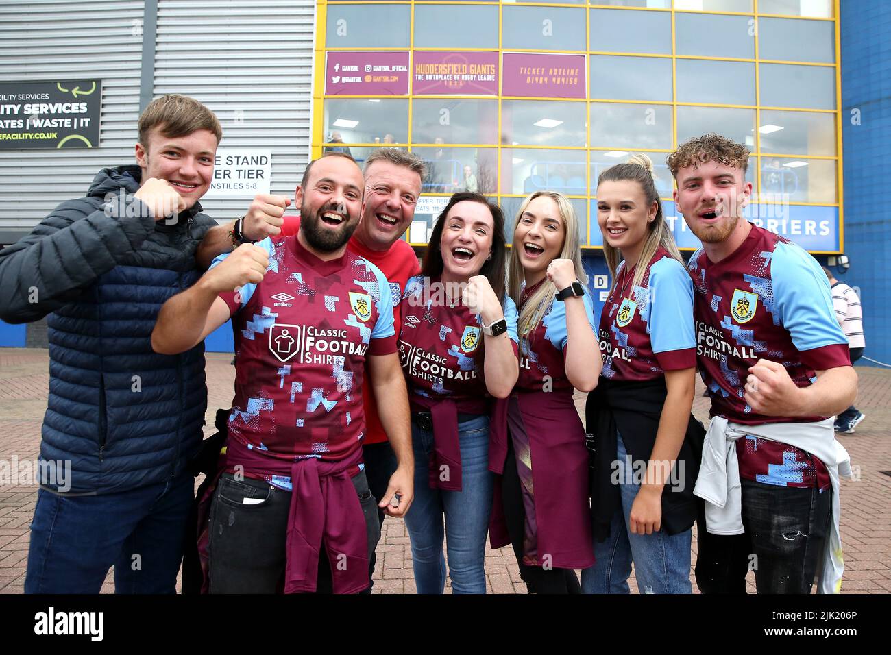 Burnley fans pose for photographers outside the stadium before the Sky ...