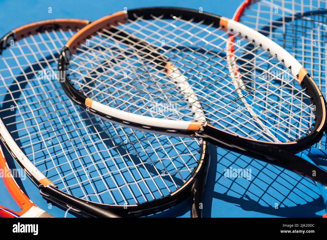 broken tennis rackets blue tennis court Stock Photo - Alamy
