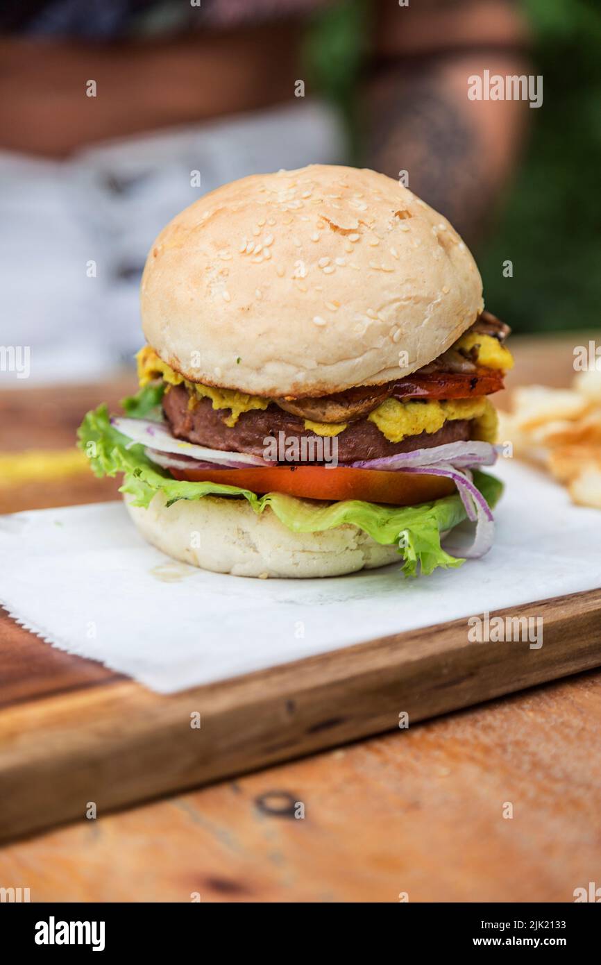 Vegetarian hamburger with egg, tomato, lettuce, onion and mushrooms on ...