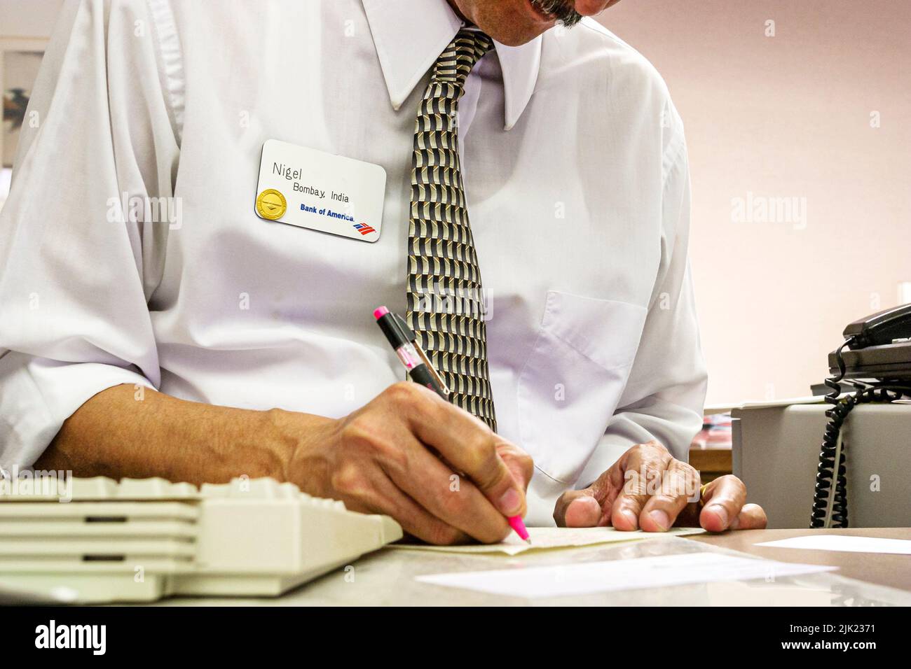 Banking bank teller writing using pen hi-res stock photography and ...