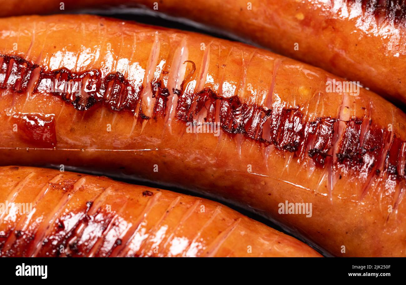 Grilled sausage on a plate. Grilled sausage with notches close-up. Food ...