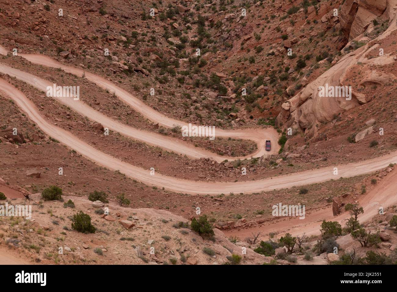 Scenic Dirt Road surrounded by Red Rock Mountains in Desert Canyon ...