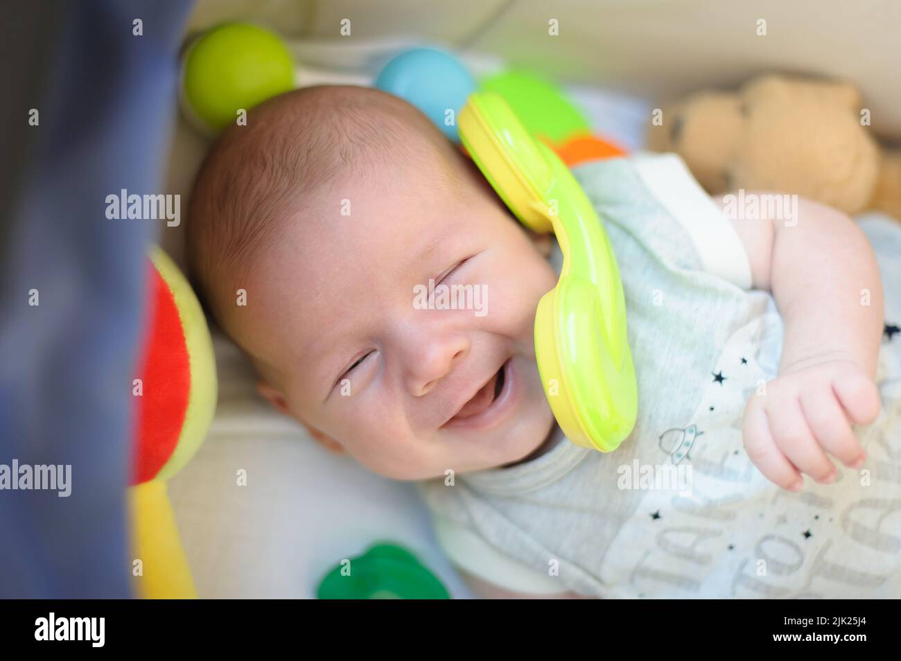 Funny baby boy is talking and using the toy telephone headset in ...
