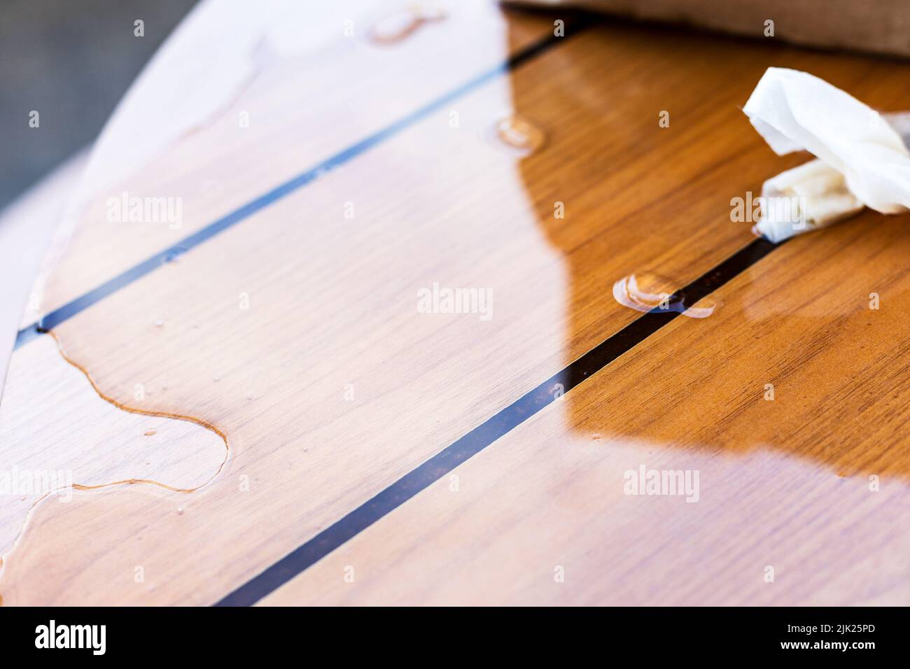 puddle of spilled beer on surface of wooden table in outdoor cafe on ...