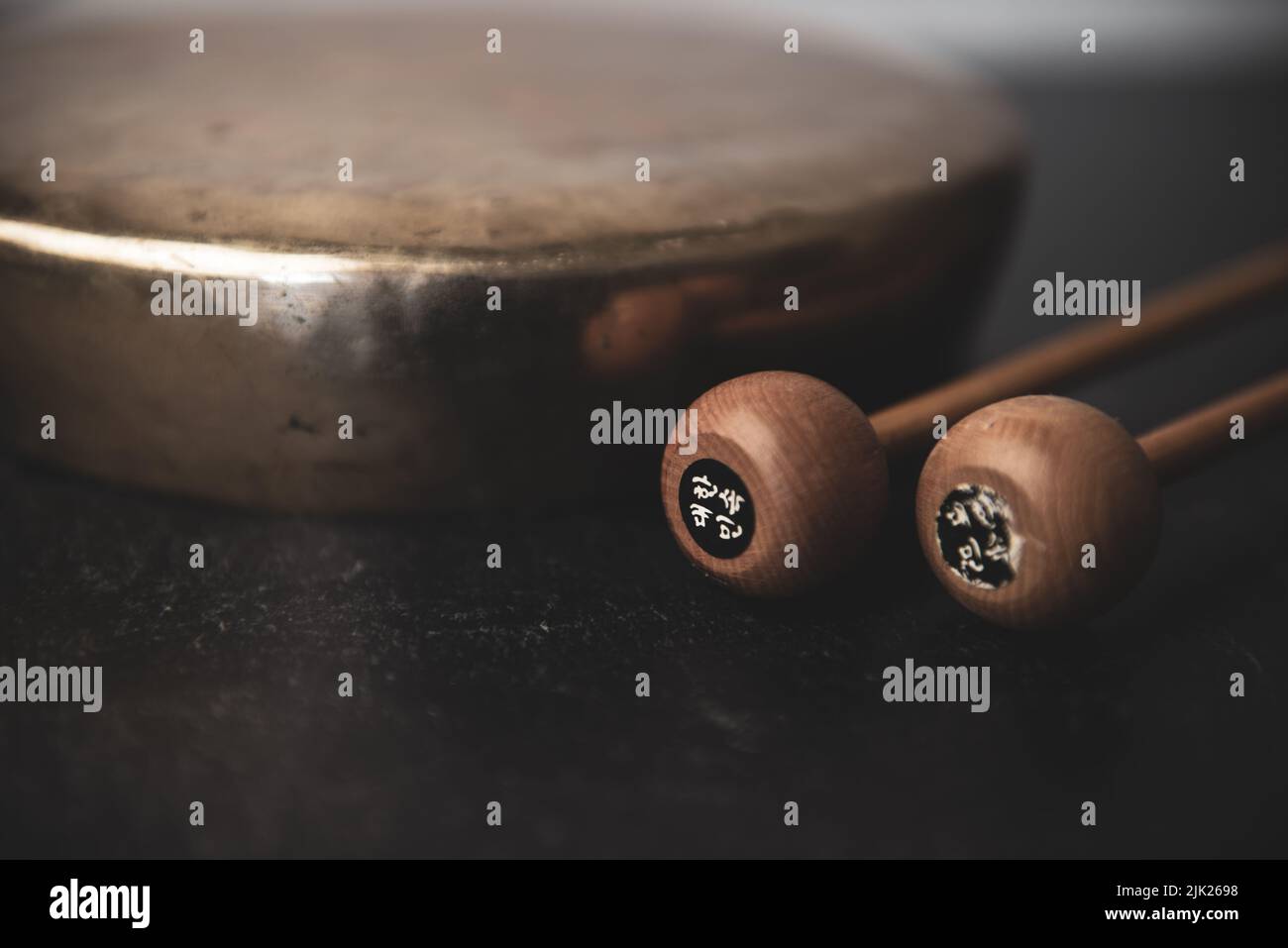 Jing Korean Traditional Gong with drumsticks on dark moody background ...