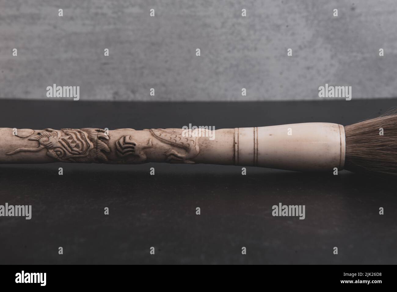 Chinese hand carved bone paintbrush on grey and black background Stock ...