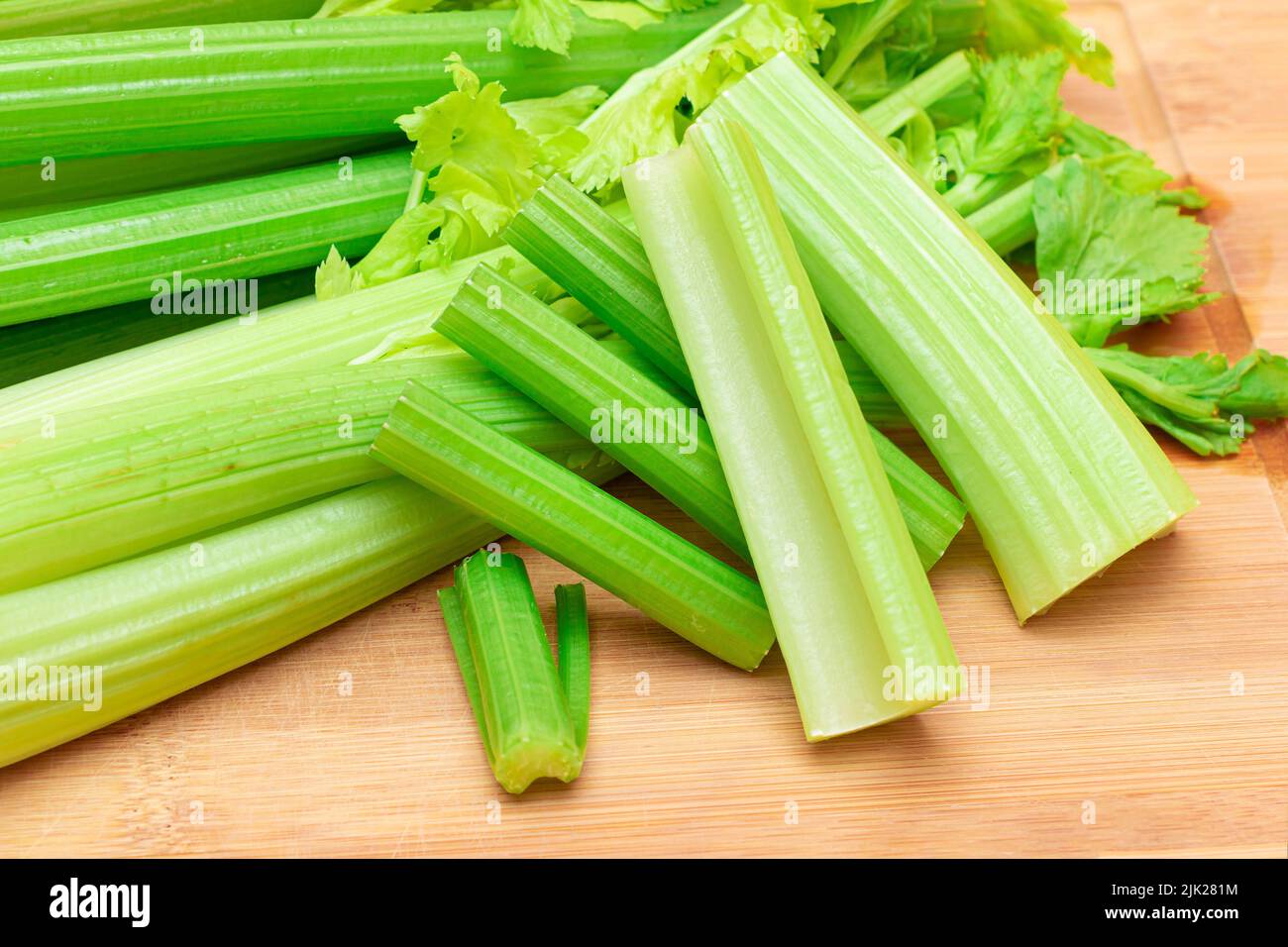 Fresh Celery Stem and Chopped Celery Sticks on Wooden Cutting Board ...