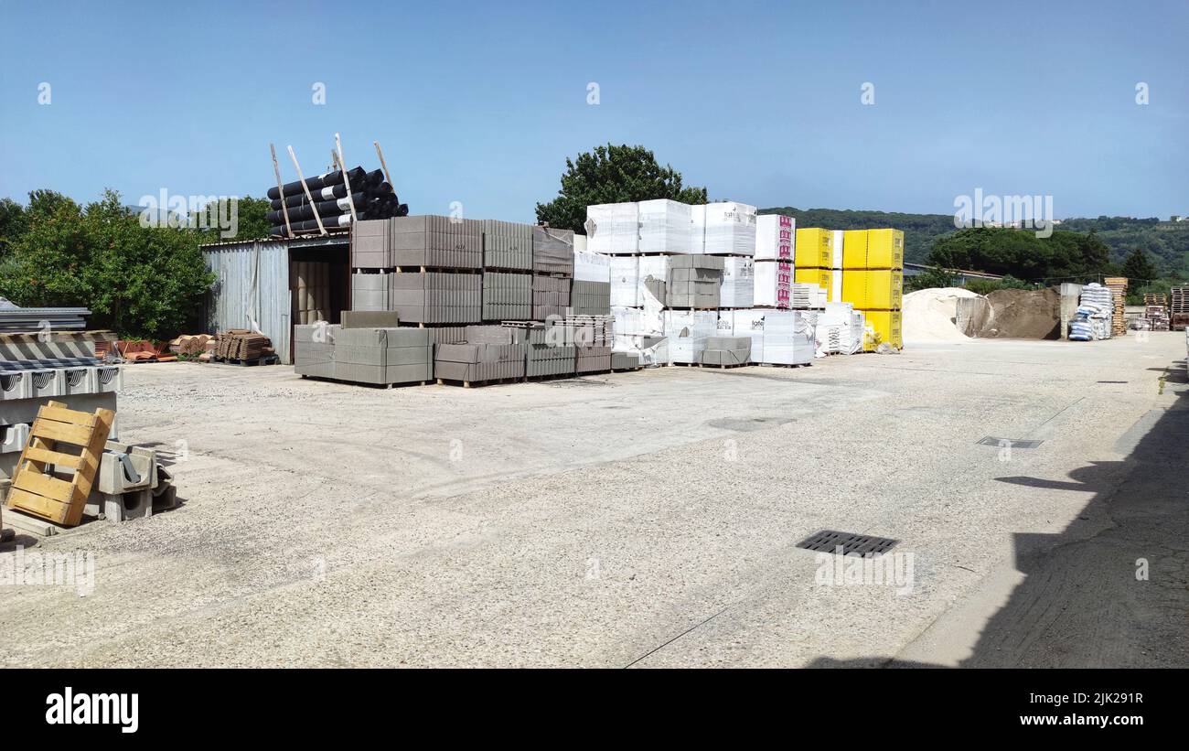 pallets and packages of freshly produced red bricks in a construction ...