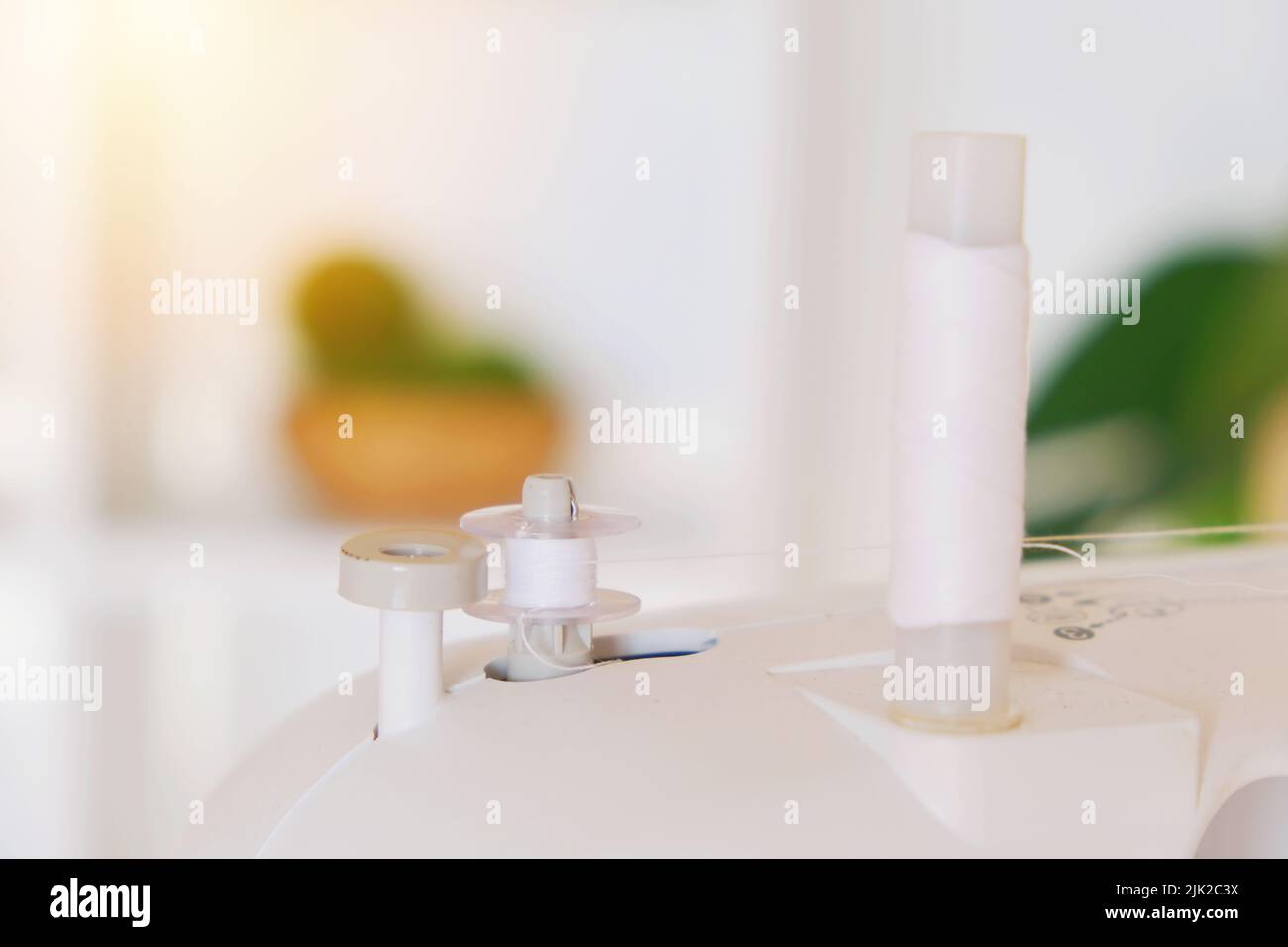 Winding threads on a bobbin on a sewing machine Stock Photo - Alamy