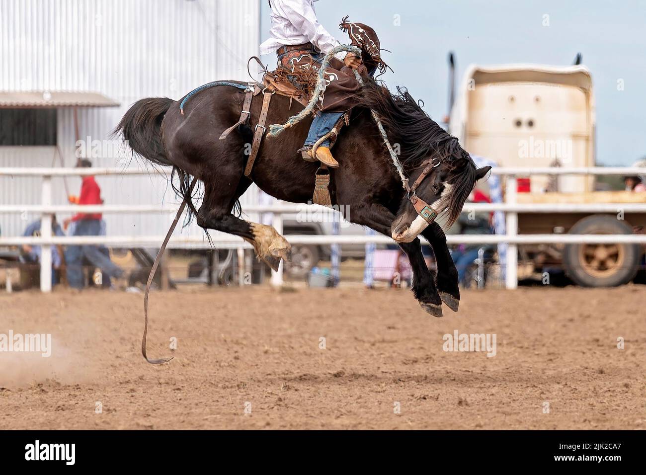 Cowboy riding a bucking bronc at a country rodeo Australia Stock Photo ...